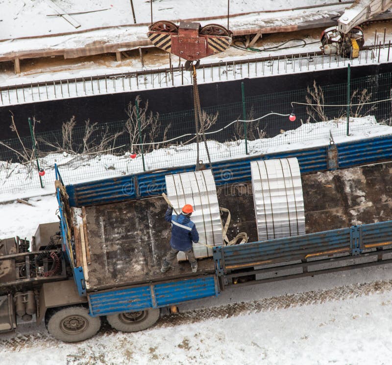 A Worker is Unloading Bricks in a Truck at a Construction Site Stock ...