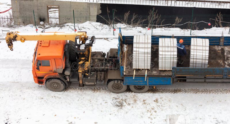 A Worker is Unloading Bricks in a Truck at a Construction Site Stock ...