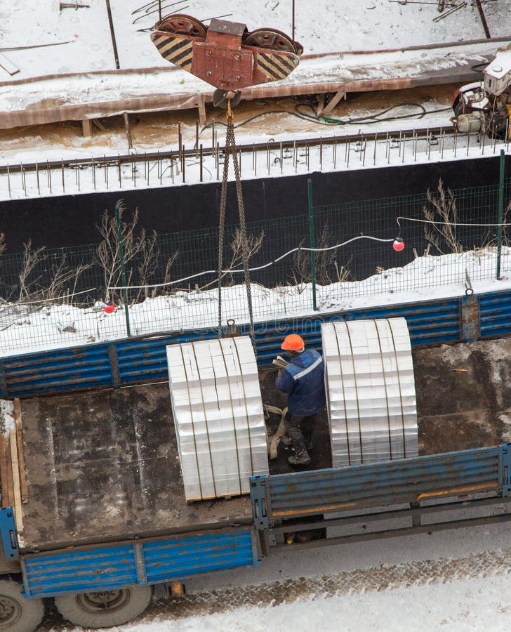 A Worker is Unloading Bricks in a Truck at a Construction Site Stock ...