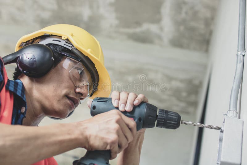 Worker unscrew the nut. stock image. Image of building - 72501595