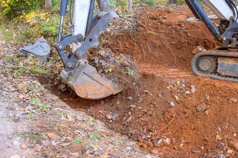 Worker Use Tractor Digs Out a Ditch for Laying Drainage Concrete Sewage ...