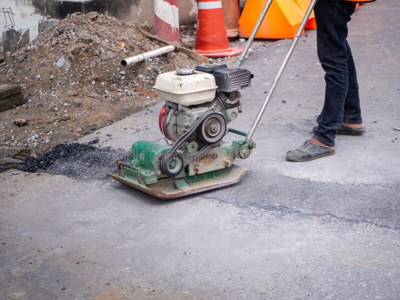 Worker Use Vibratory Plate Compactor Compacting Asphalt at Road Stock ...