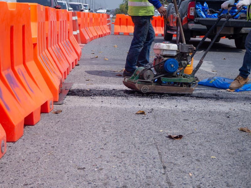 Worker Use Vibratory Plate Compactor Compacting Asphalt at Road Stock ...