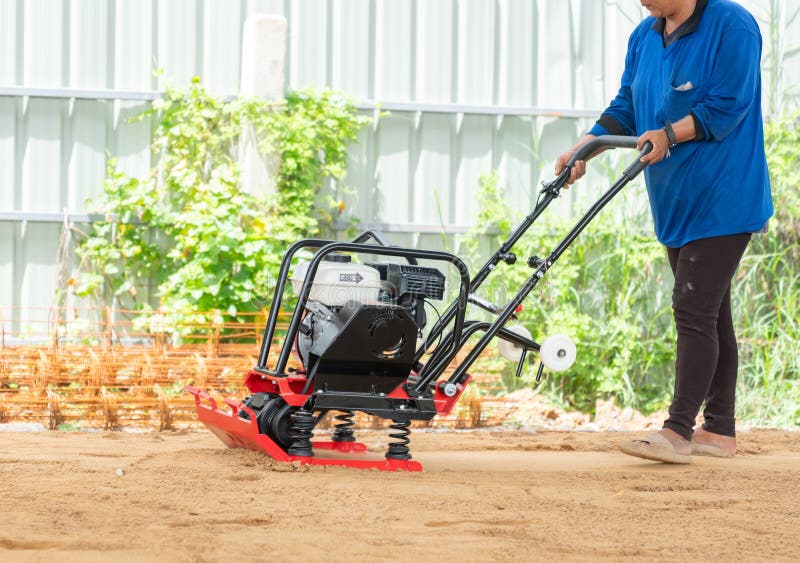 Worker in Use Vibratory Plate Compactor for Compaction Sand Stock Photo ...