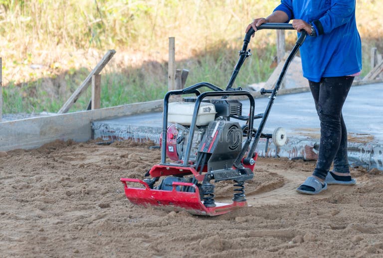 Worker in Use Vibratory Plate Compactor for Compaction Sand Stock Photo ...