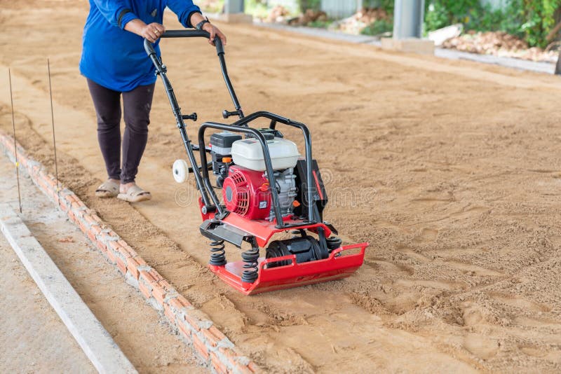 Worker Use Vibratory Plate Compactor at Road Construction Site Stock ...