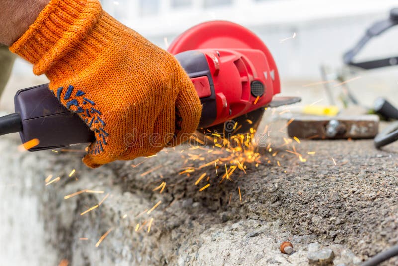 The Worker Uses an Angle Drive Grinder To Work with a Metal Corner ...