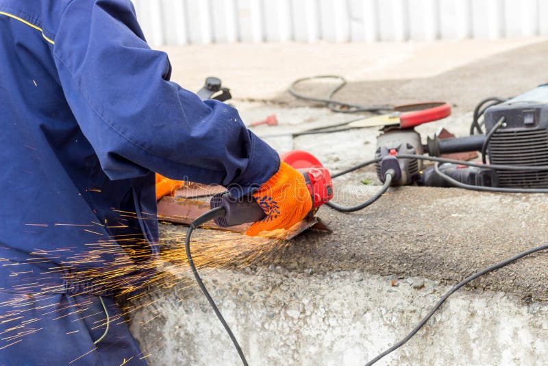 The Worker Uses an Angle Drive Grinder To Work with a Metal Corner ...