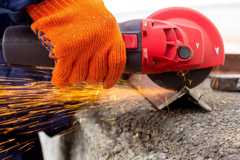 The Worker Uses an Angle Drive Grinder To Work with a Metal Corner ...