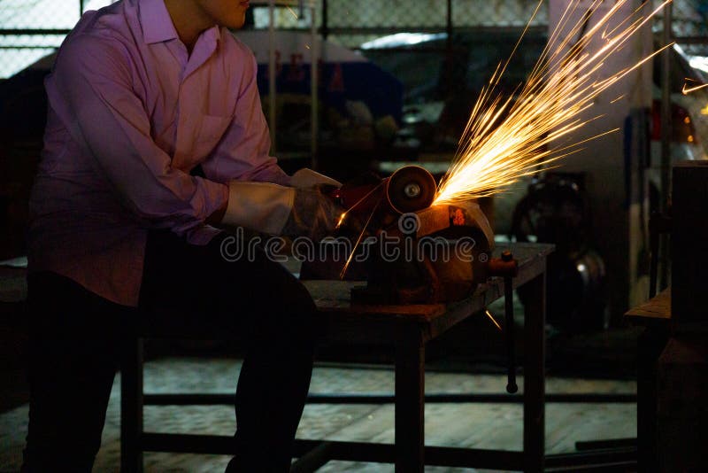 The Worker Uses Cutting Machine To Cut Metal, Focus on Flash Light Line ...