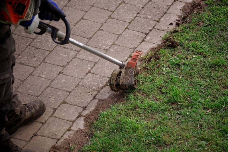 Worker Uses Edge Trimmer at the Pathway Stock Image - Image of string ...