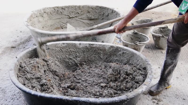The Worker Uses a Hoe To Mix Cement. Stock Footage - Video of color ...