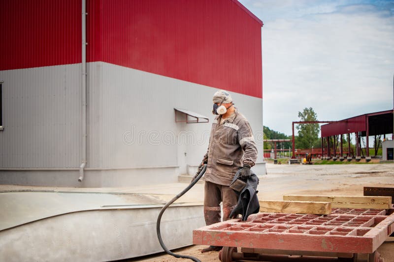 Worker Sandblasting a Large Metal Structure To Remove Rust at an ...