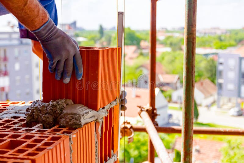 Worker Uses a Spirit Level To Control Wall Made of Red Blocks Stock ...