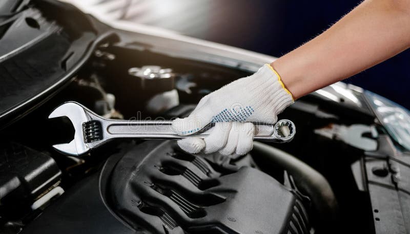 Worker Using Adjustable Wrench To Perform Maintenance Near Engine Stock ...