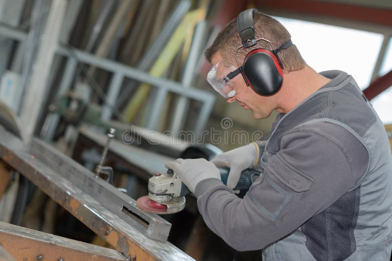 Worker using angle grinder stock image. Image of metalworker - 127173779
