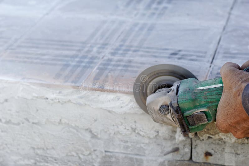 Worker Using an Angle Grinder Cutting Concrete and Tile Stock Photo ...