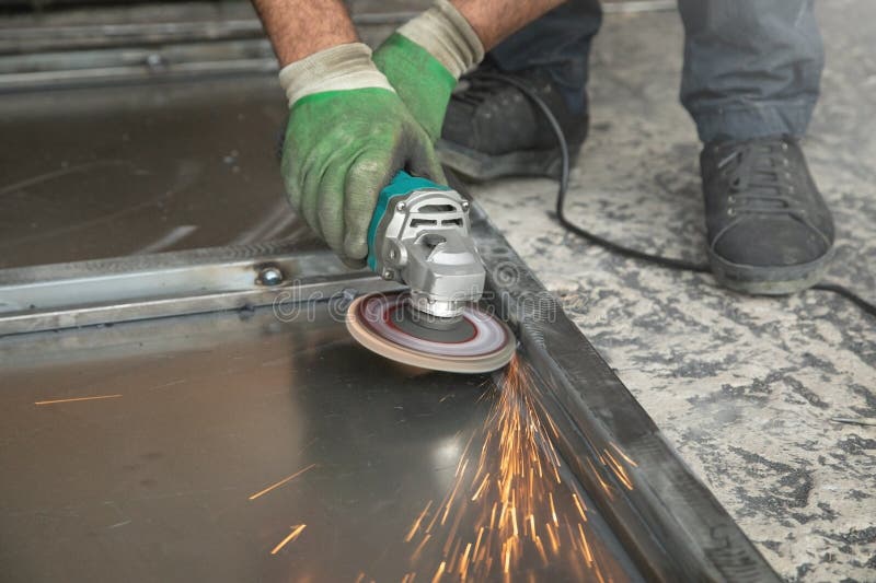 Worker Using Angle Grinder. Cutting Detail of Iron Gate Stock ...