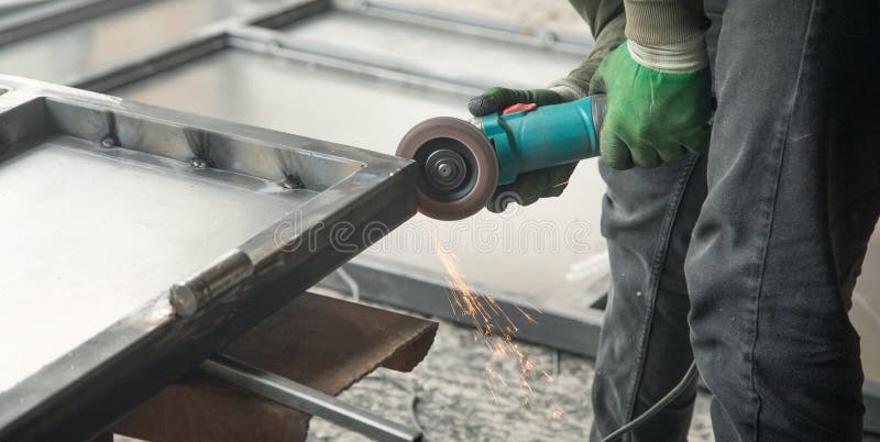 Worker Using Angle Grinder. Cutting Detail of Iron Gate Stock Photo ...