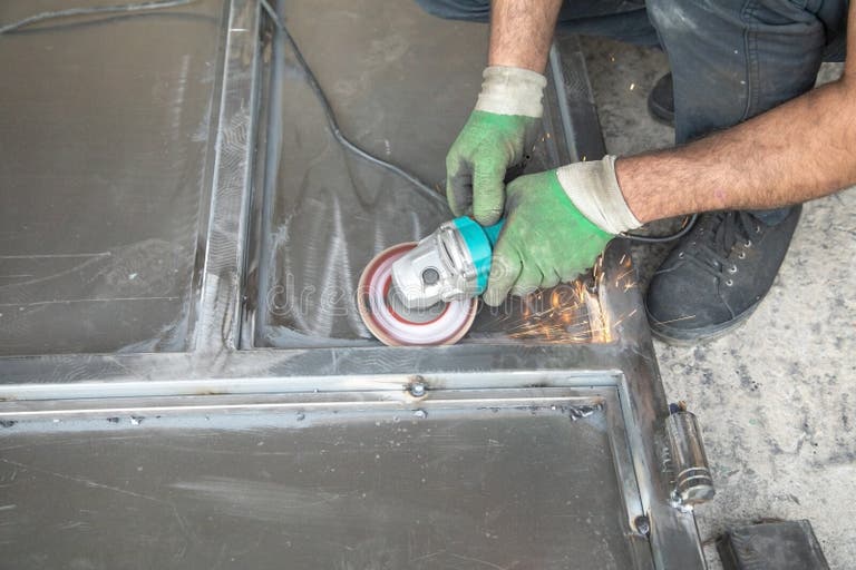 Worker Using Angle Grinder. Cutting Detail of Iron Gate Stock Photo ...