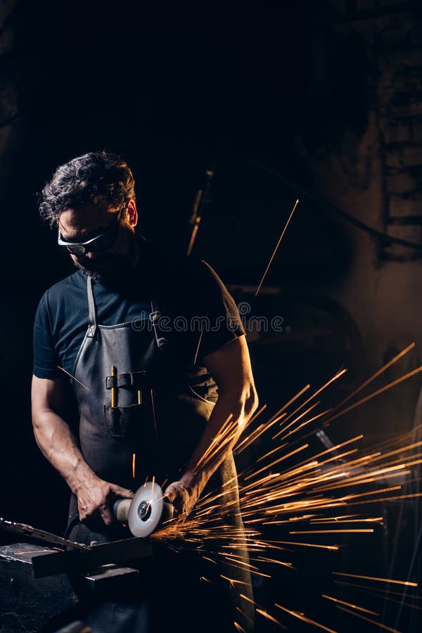 Man Using Angle Grinder in Factory and Throwing Sparks Stock Photo ...