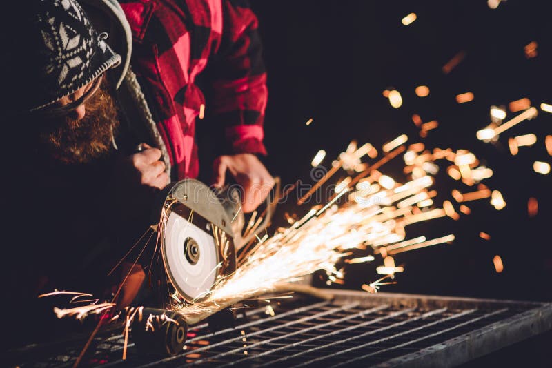 Worker Using Angle Grinder in Factory and Throwing Sparks. Stock Image ...