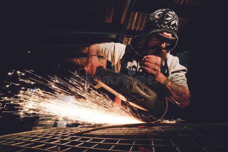 Worker Using Angle Grinder in Factory and Throwing Sparks. Stock Image ...