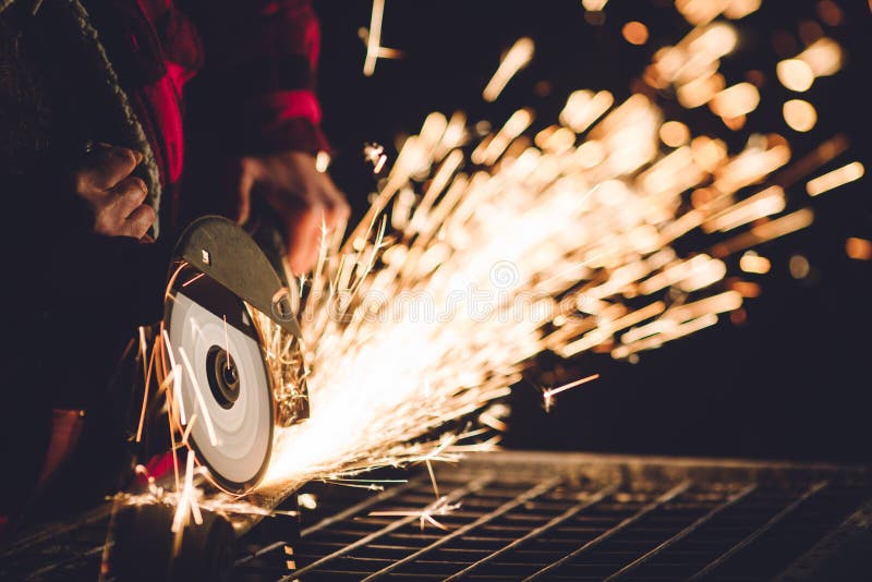 Worker Using Angle Grinder in Factory and Throwing Sparks. Stock Image ...