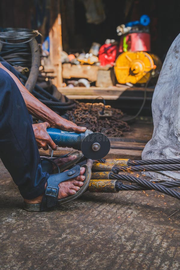 Worker Using Angle Grinder on Thick Metal Cables in Workshop Stock ...