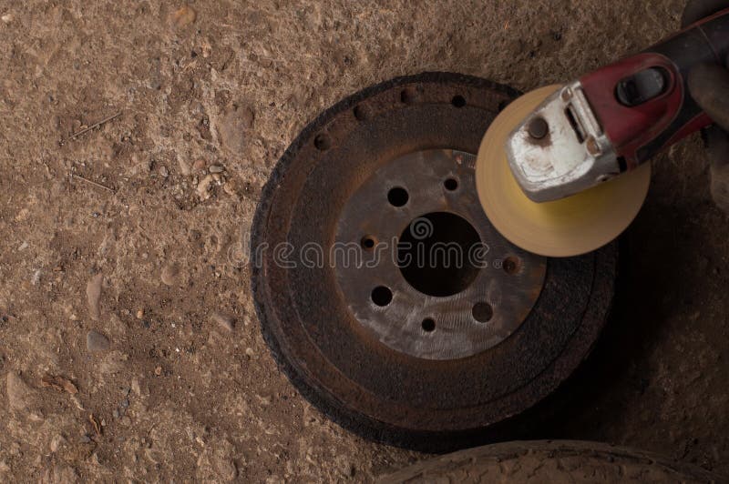 Worker Using Angle Grinder in Workshop.Car Disk Processing Stock Photo ...