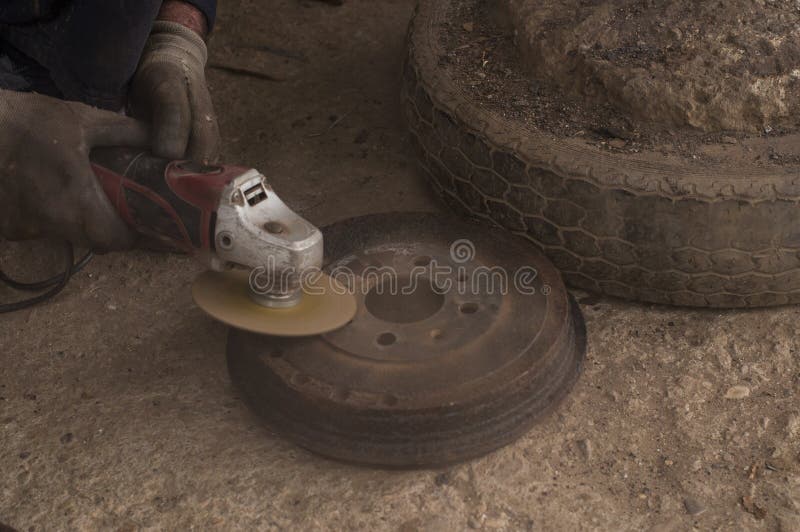 Worker Using Angle Grinder in Workshop.Car Disk Processing Stock Image ...