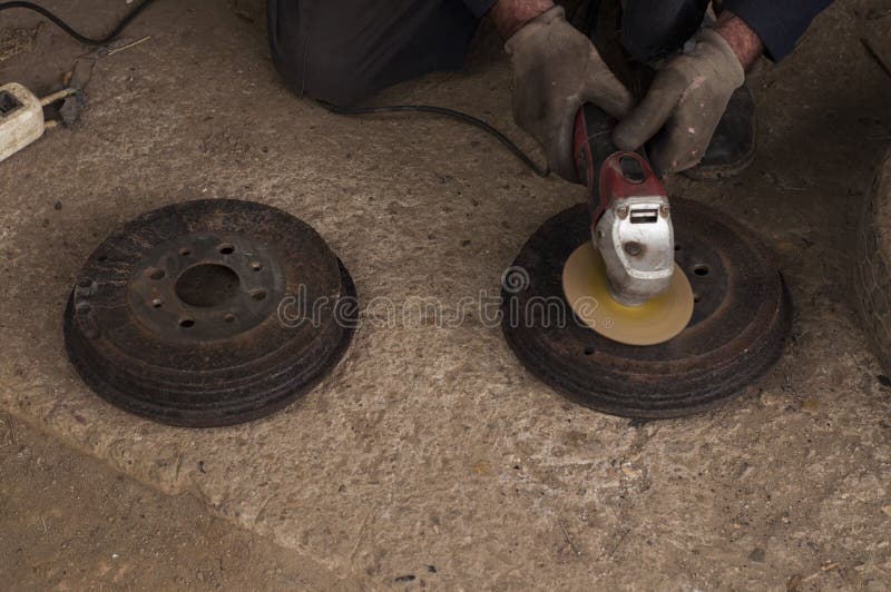 Worker Using Angle Grinder in Workshop.Car Disk Processing Stock Image ...