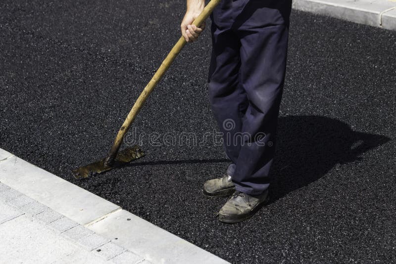 Using a Rake To Level Asphalt Pavement Stock Photo - Image of bitumen ...