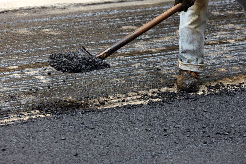 Worker Using Asphalt Paver Tool during Road Construction. Stock Photo ...