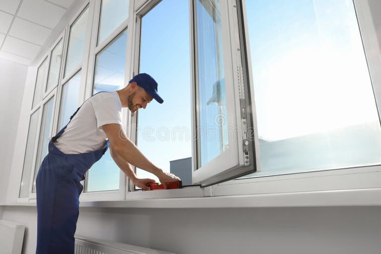 Worker Using Bubble Level after Plastic Window Installation Indoors Stock Photo - Image of ...