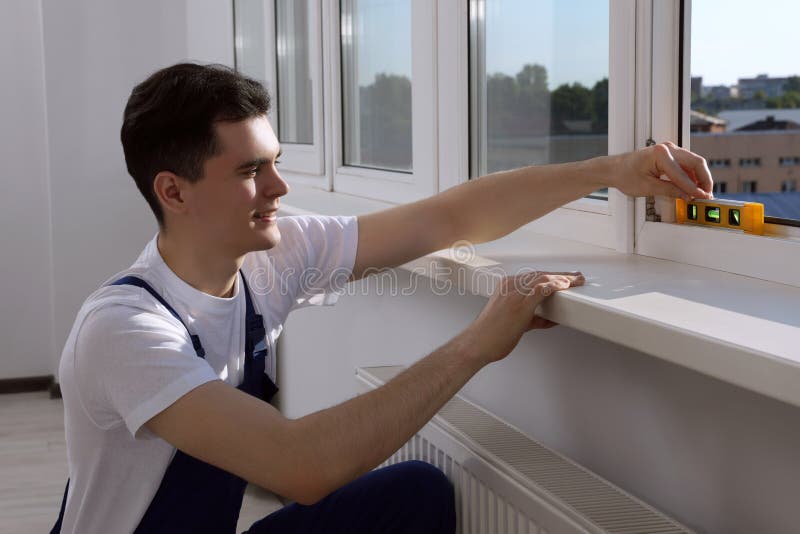 Worker Using Bubble Level after Plastic Window Installation Stock Photo ...