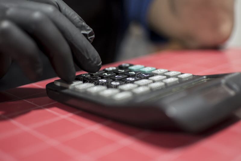 Worker Using a Calculator on a Counter Stock Photo - Image of cashier ...