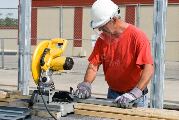 Worker using Chop Saw stock image. Image of construction - 6671693