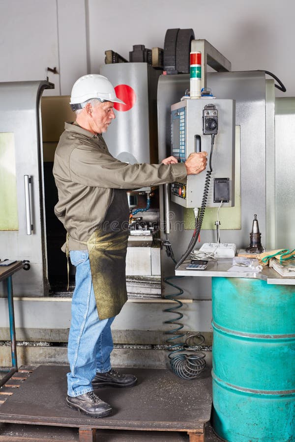 Worker using CNC machine stock photo. Image of production - 103873478
