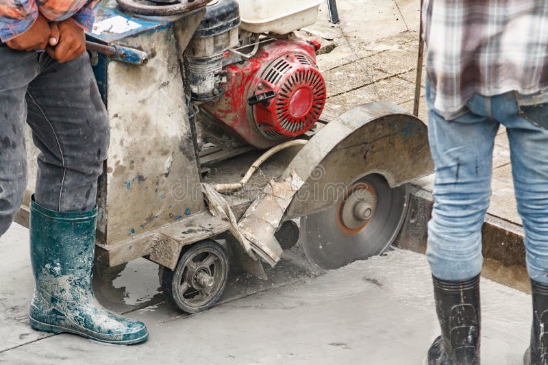 Worker Using Diamond Saw Blade Machine Cutting Concrete Road at ...