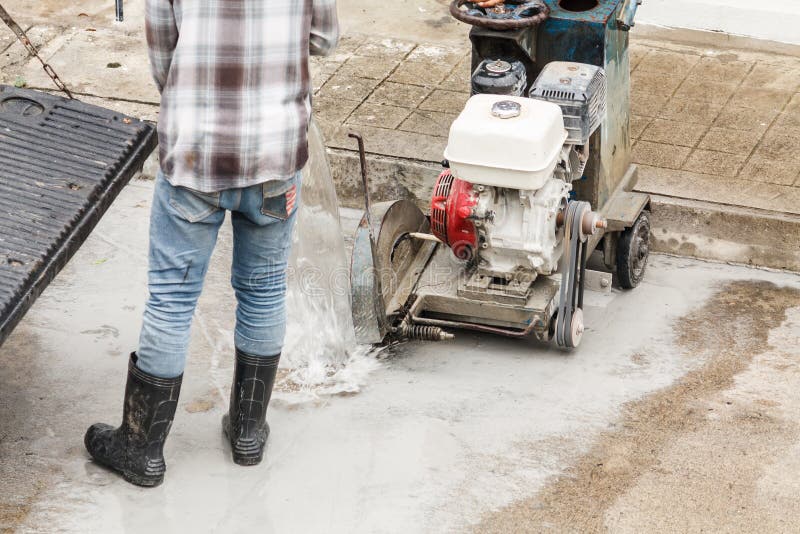 Worker Using Diamond Saw Blade Machine Cutting Concrete Road at ...