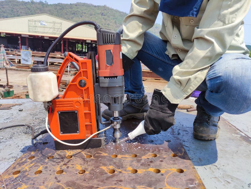 Worker are Using a Drilling Machine To Drill a Hole on Steel Plate at ...