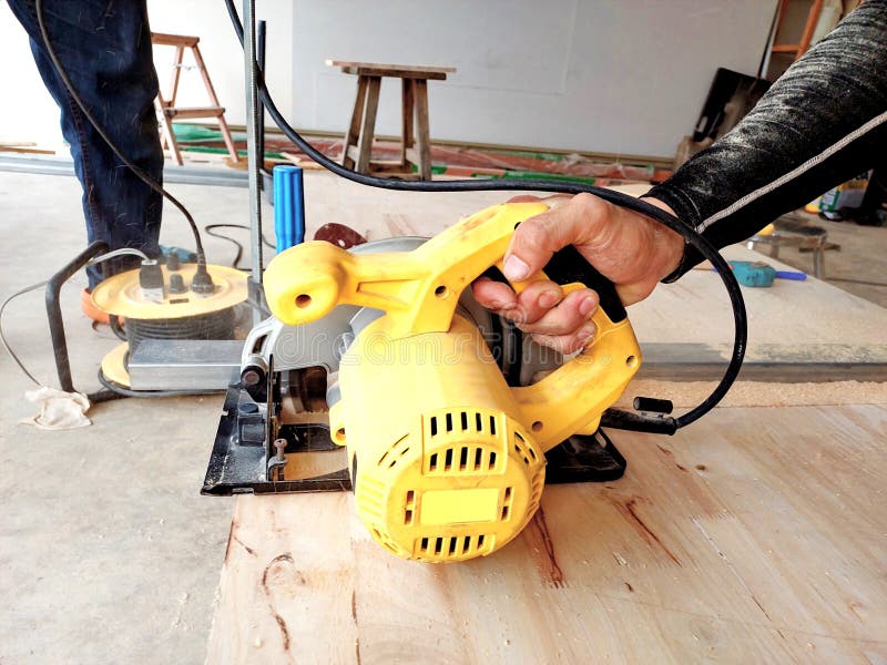 Worker Using Electric Circular Saw Cutting Plank Wood Stock Image ...