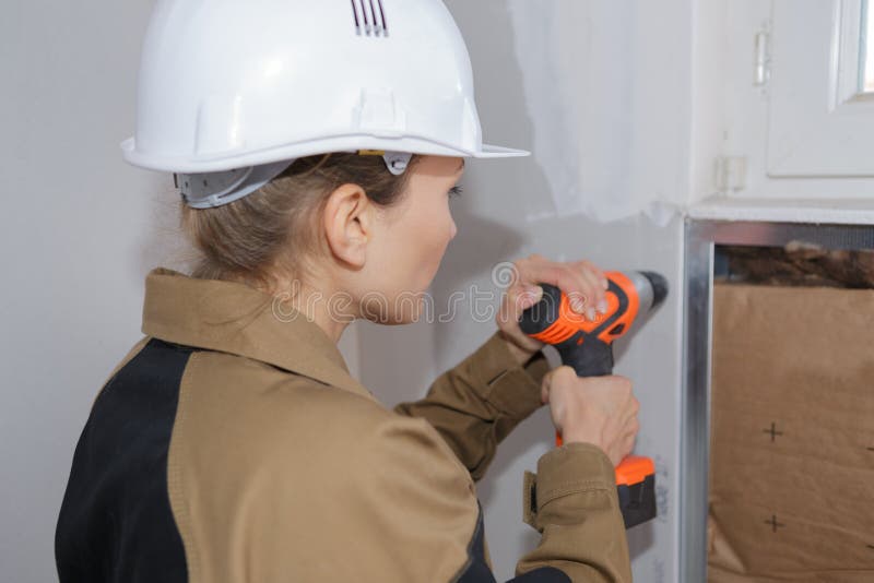 Worker Using Electric Drill Stock Image - Image of drilling, wall: 96540701