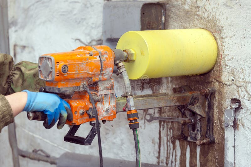 Worker Using an Electric Drill To Make a Hole in a Concrete Wall ...