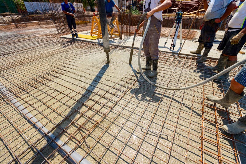 Worker is Using Electric Vibratory To Compact Concrete in Foundation ...