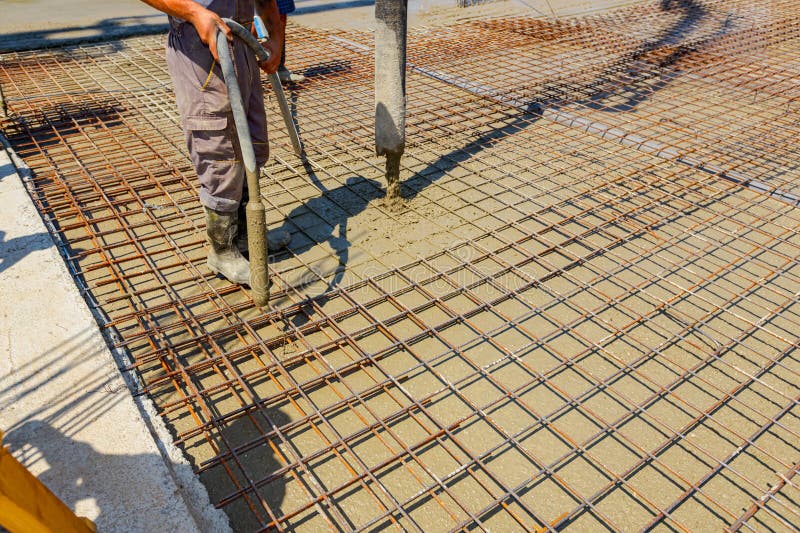 Worker is Using Electric Vibratory To Compact Concrete in Foundation ...