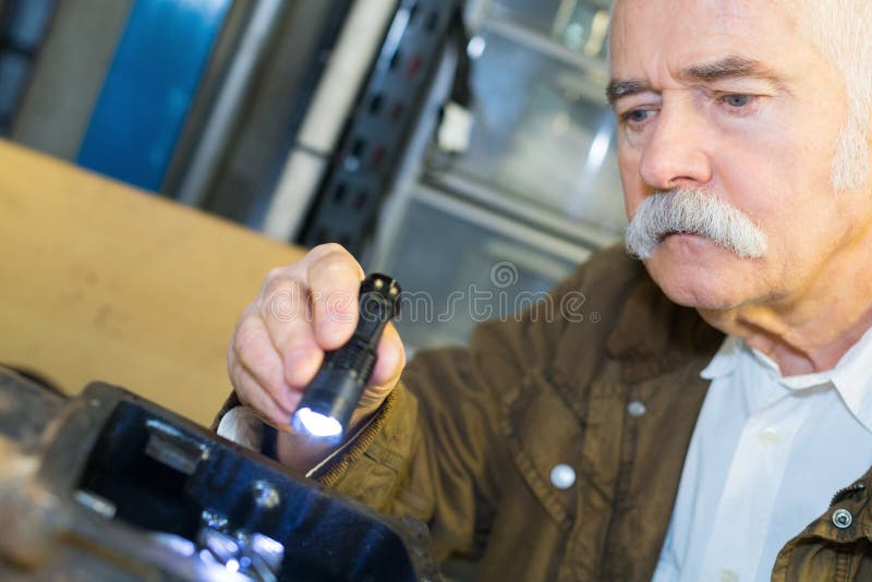 Worker Using Flashlight To Inspect Something Stock Photo - Image of ...