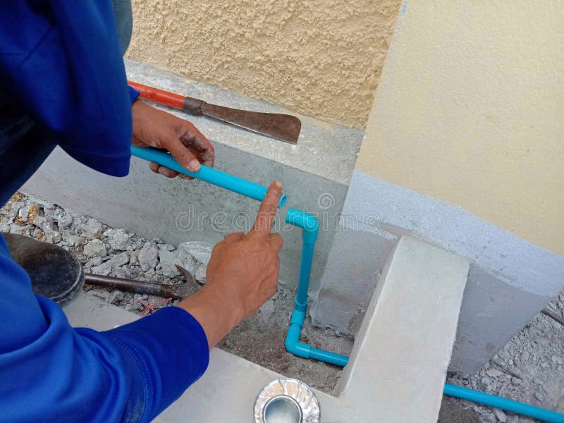 Worker is Using Glue with Pipe Fitting for Installing the Blue PVC ...