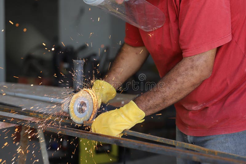 Worker Using Grinder on Metal. Blacksmith Cutting Metal Stock Image ...